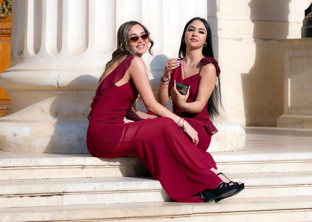 girls, women, bridesmaid, fashion, red dress, dress, glasses, phone, sitting, stairs, building, overview, outdoor, lifestyle